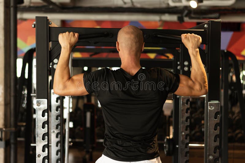 Sports Man Make Pull Ups on Horizontal Bar at Gym. Workout Stock Photo ...