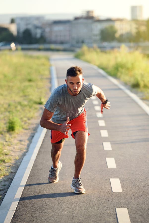 Sports Man Runner with Smart Watch in Start Position Preparing To Run ... Sports Man Runner with Smart Watch in Start Position Preparing To Run ...