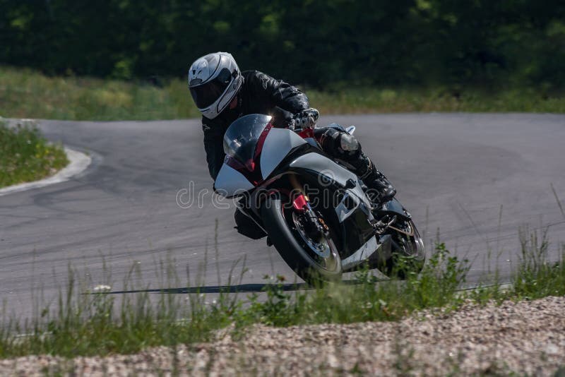 The Sports Motorcycle at High Speed Overcomes a Sharp Corner Stock ...