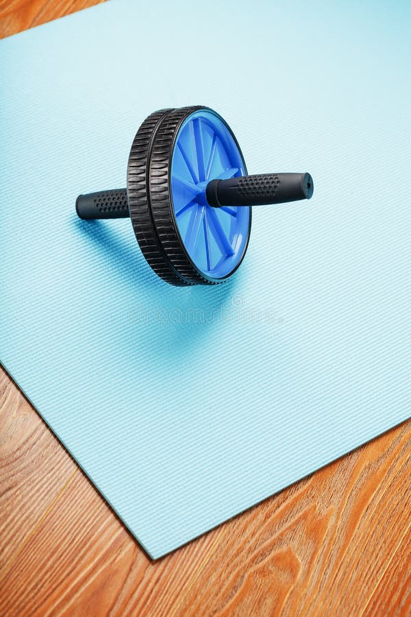 Sports Roll for Training Muscles and Abs on the Blue Mat Stock Photo ...
