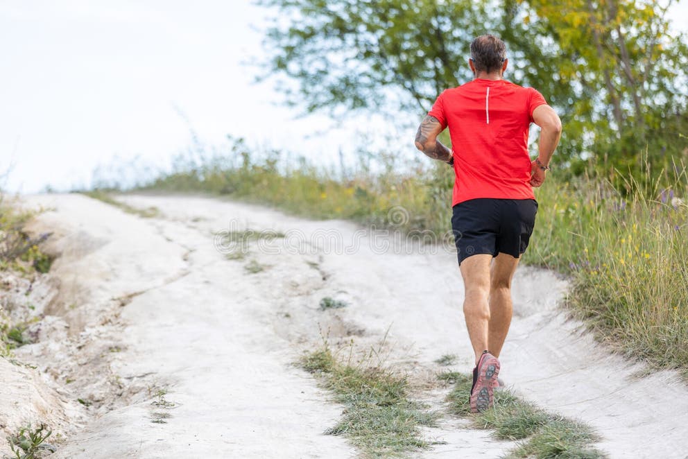 Sporty Bearded Man Running on the Path at Hillside Stock Image - Image ...