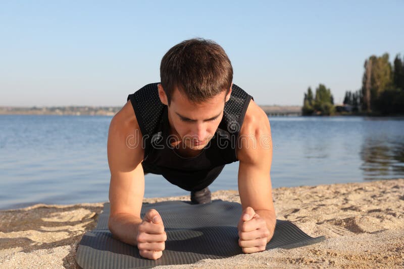 Sporty Man Doing Plank Exercise on Beach Stock Image - Image of ...