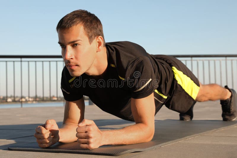 Sporty Man Doing Plank Exercise on Mat Outdoors Stock Image - Image of ...
