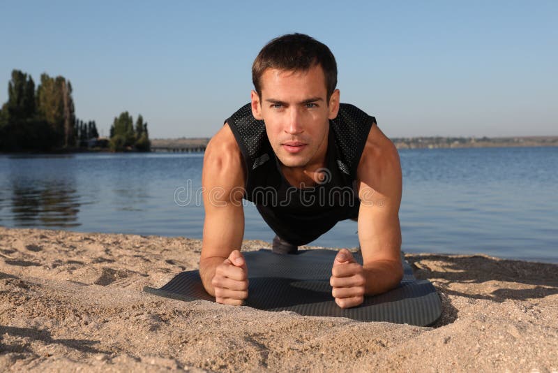 Sporty Man Doing Plank Exercise on Beach Stock Image - Image of river ...