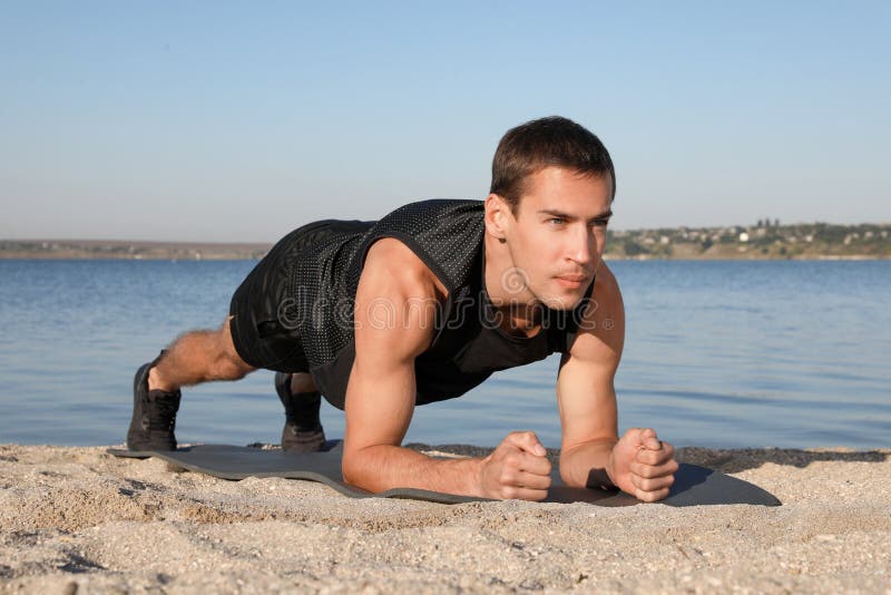Sporty Man Doing Plank Exercise on Beach Stock Photo - Image of care ...