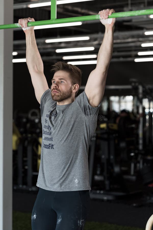 Sporty man doing pull ups stock image. Image of muscle - 59850559