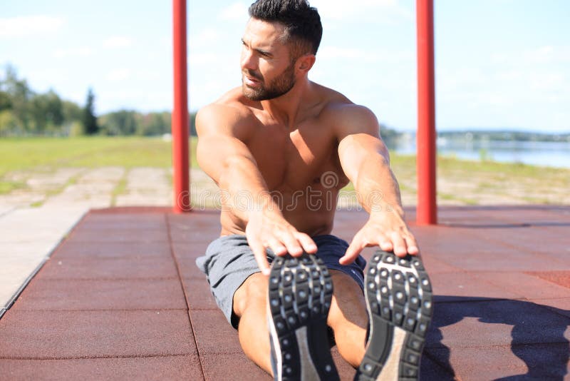 Sporty Man Doing Workout Stretching Exercises for Legs Outdoors Stock ...