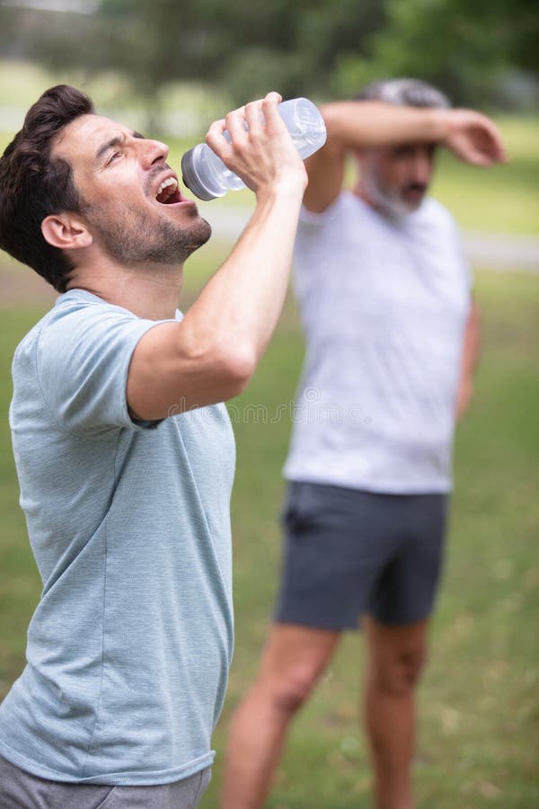 Sporty Man Drinking Water In Park Stock Photo - Image of instructor ...