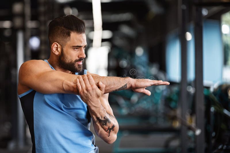 Sporty Man at Gym Doing Stretching Exercises for Hands Stock Image ...