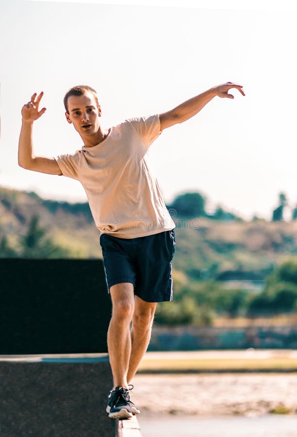 Sporty Man Keep Balancing while Walk on the Edge Stock Photo - Image of ...