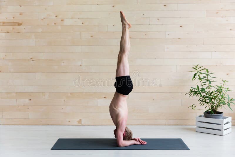 Sporty Man Practicing Yoga. Head Stand Stock Photo - Image of head ...