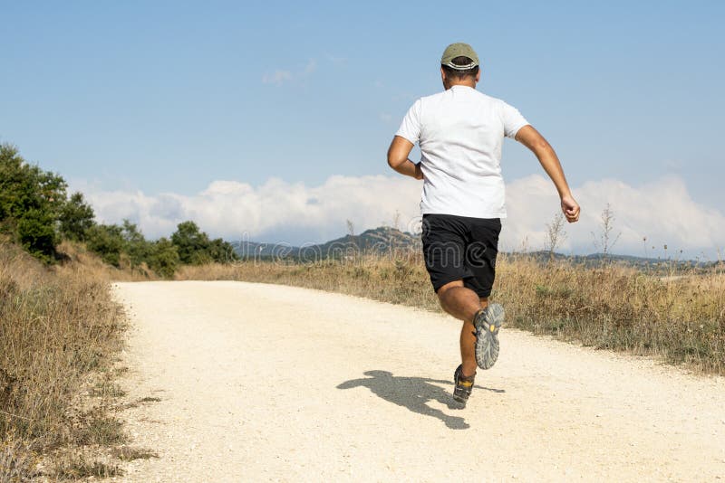 Sporty Man Running Down the Sandy Track. Stock Photo - Image of fitness ...