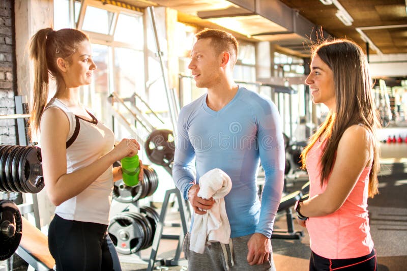 Sporty People Relaxing and Talking after Class in Gym. Stock Photo ...