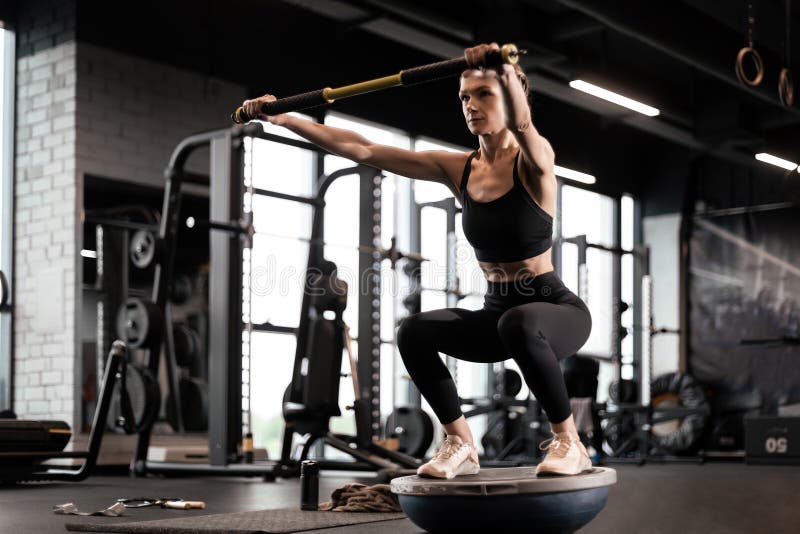 Sporty Woman Making Squats on Balance Trainer. Stock Image - Image of ...