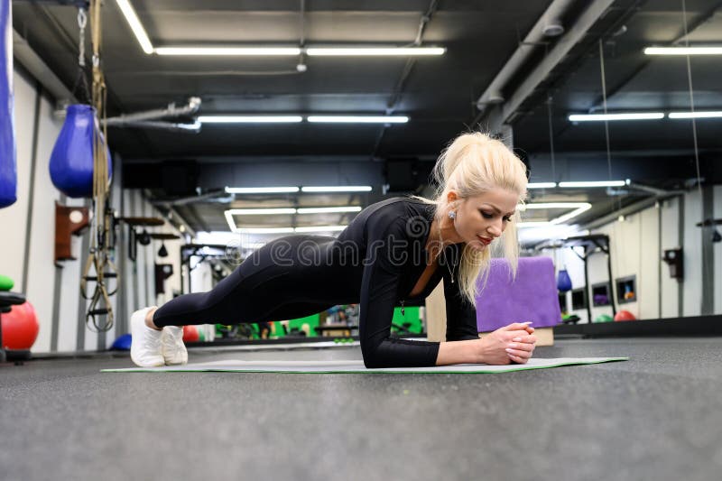 Sporty Woman Performs Plank Exercise on Workout in the Gym Stock Photo ...