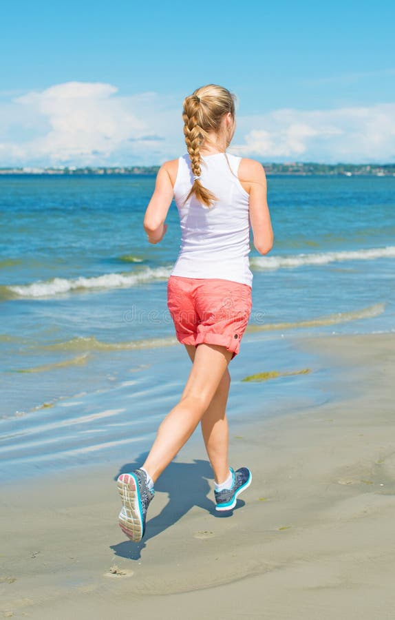 Sporty Woman Running Along the Beach. Stock Photo - Image of healthy ...