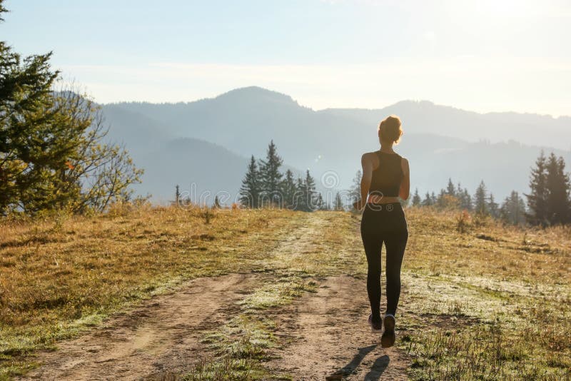 Sporty Woman Running in Mountains, Back View Stock Photo - Image of ...