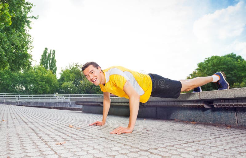 Sporty Young Man Doing Plank Exercise Outdoors Stock Photo - Image of ...