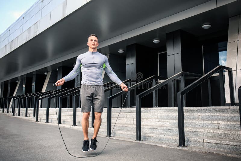 Sporty Young Man Jumping Rope Outdoors Stock Photo - Image of body ...