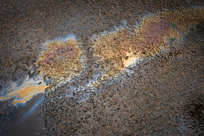 A Spot of Oil or Gasoline in a Puddle on the Asphalt. Top View of ...