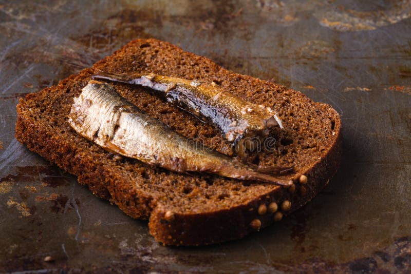 Sprat on a Piece of Black Bread. Fish with Bread Stock Image - Image of ...