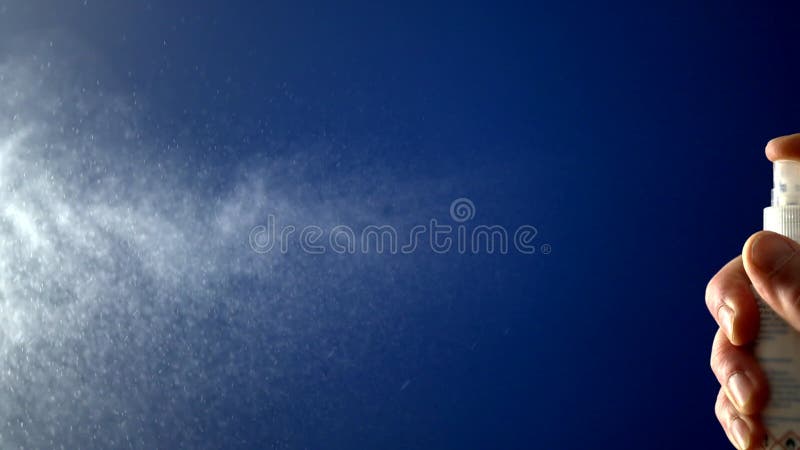 Spray from a Spray Bottle on a Blue Background Slow Motion Stock Video ...