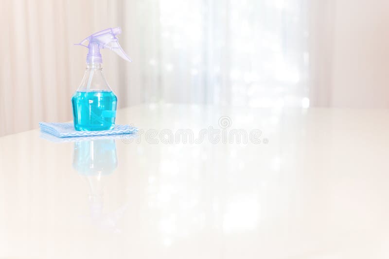 Spray Bottle with Liquid on a White Table Stock Photo - Image of blue ...