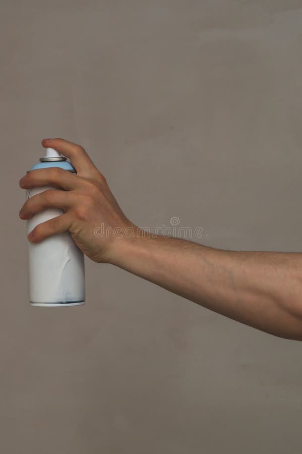 Spray Can in Hand. Spraying Paint on the Wall. Painting Process Stock ...