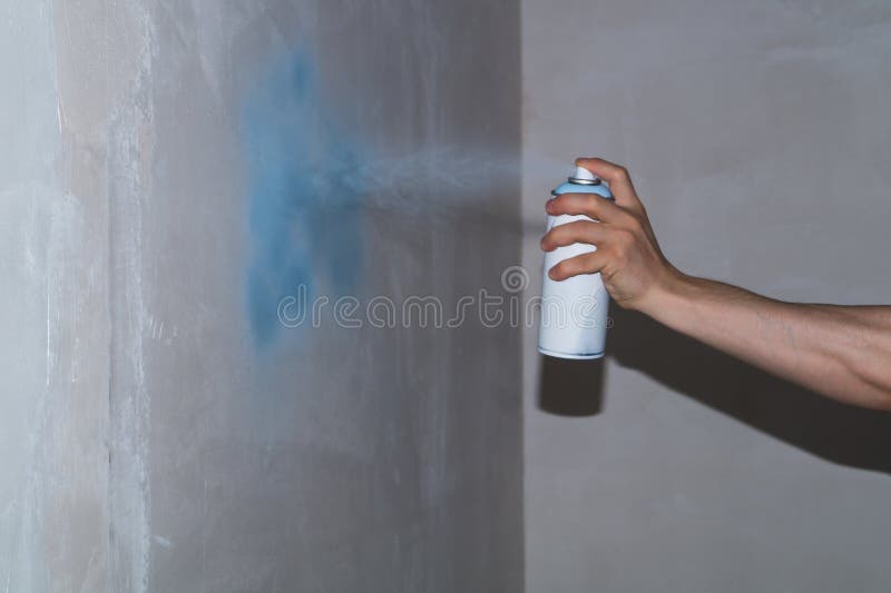 Spray Can in Hand. Spraying Paint on the Wall. Painting Process Stock ...