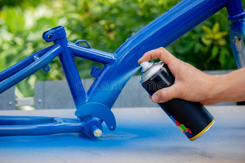 Spray Painting a Bicycle Frame Outdoors Stock Image - Image of polish ...