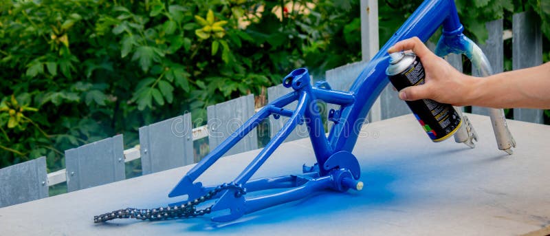 Spray Painting a Bicycle Frame Outdoors Stock Image - Image of fixing ...