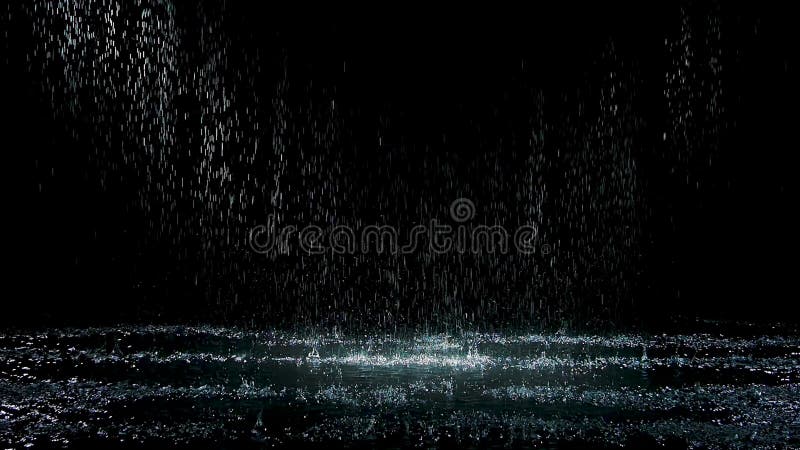 Spray Spatters Rain Fall Against on the Water Surface Which Glow. Black ...