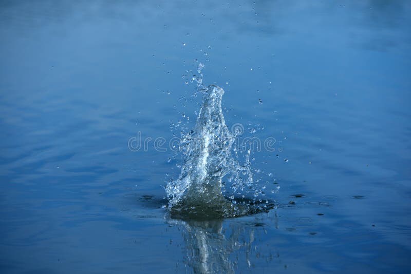 Spray of Water from a Thrown Stone into the Water Stock Photo - Image ...