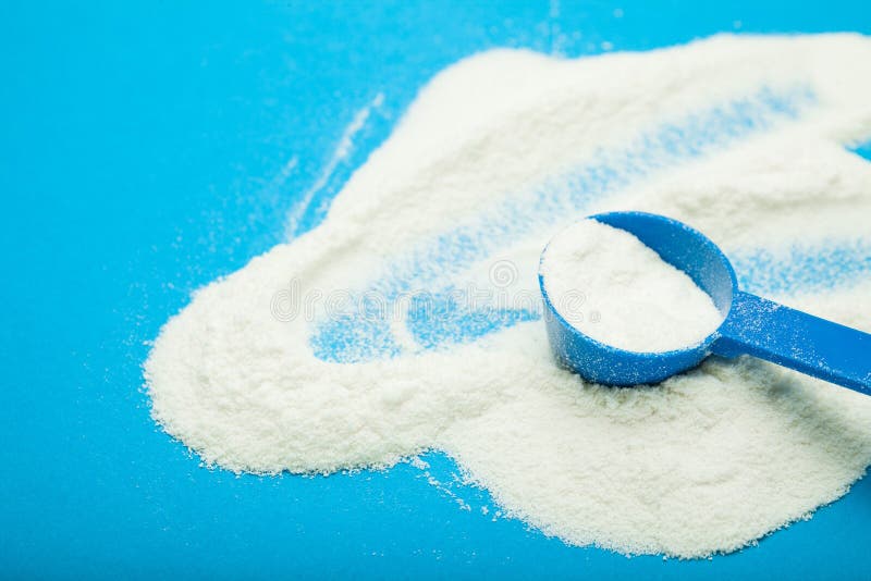 Sprayed Powdered Milk on a Blue Background Stock Photo - Image of full ...