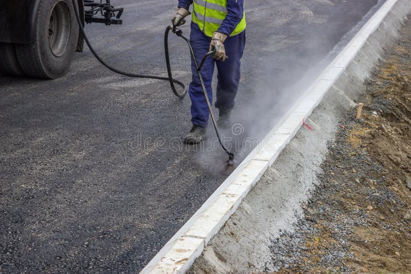 Spraying Bitumen Emulsion with the Hand Spray Lance Stock Image - Image ...