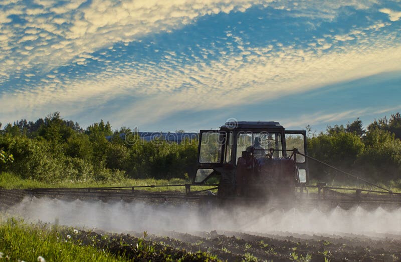 Spraying Crops with Herbicides Using Sprayer Mounted on Wheeled Tractor ...