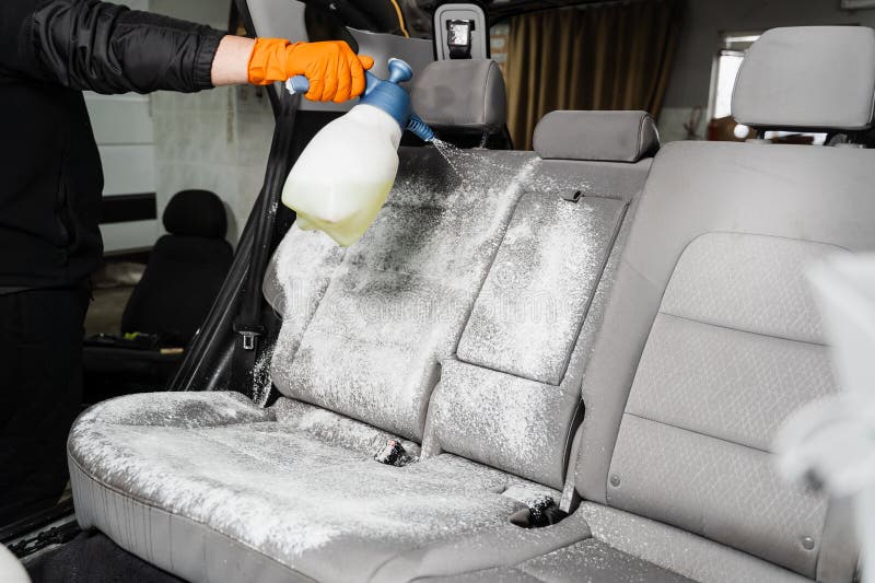 Spraying Detergent on Textile Seats in Car Interior for Dry Cleaning ... Spraying Detergent on Textile Seats in Car Interior for Dry Cleaning ...