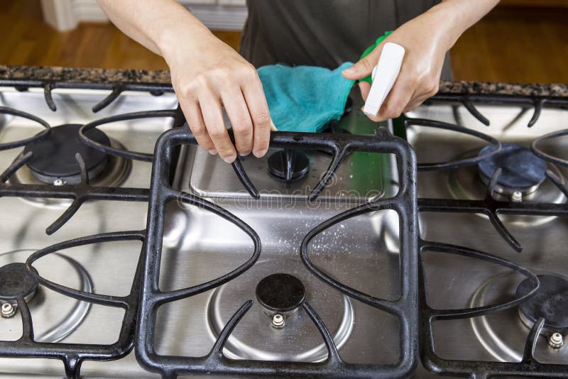 Cleaning Stove Top with Microfiber Cloth Stock Photo - Image of curved ...
