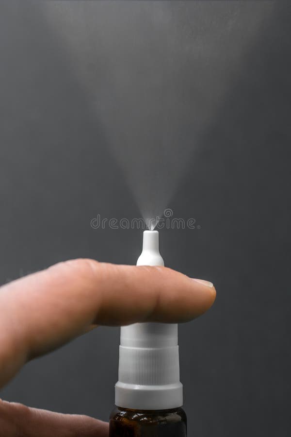 Spraying Nasal Spray in Front of Black Background Stock Photo - Image ...