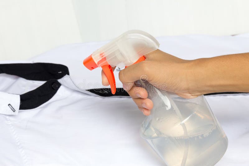 Spraying a Cloth with Laundry Detergent in Spray Bottle Stock Image ...