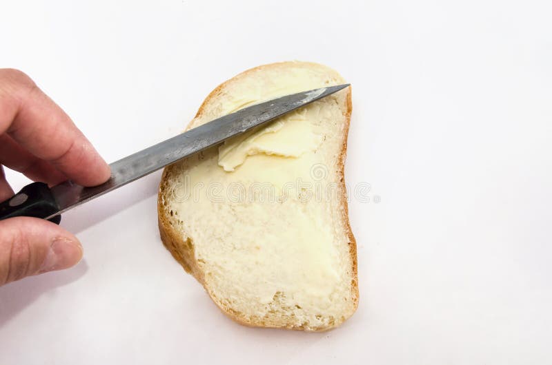 Spread Butter on a Slice of White Bread with a Knife. View from Above ...