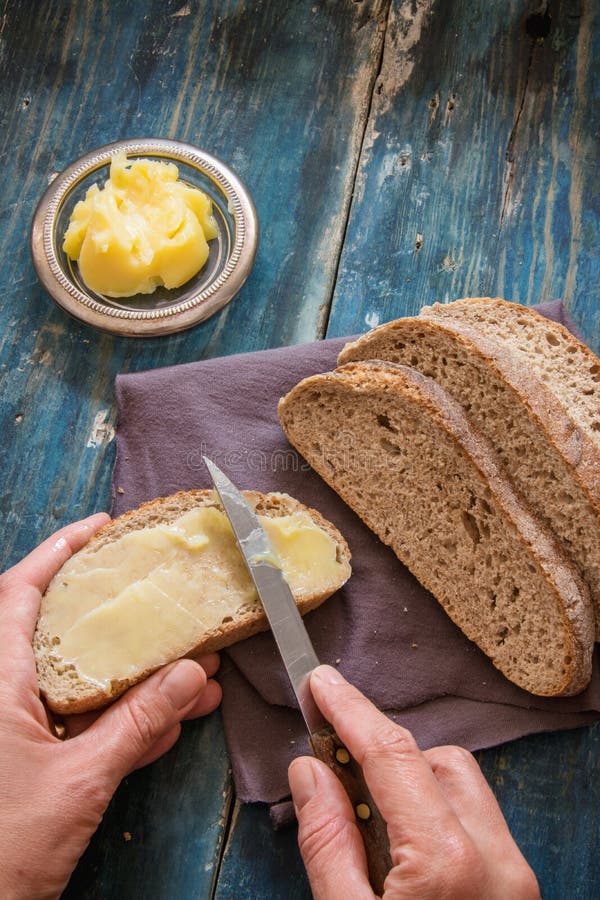 Spread Fresh Butter on Whole Wheat Bread Stock Photo - Image of person ...