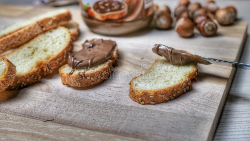 Spreading Chocolate-nut Cream on Bread with Sesame Seeds Stock Photo ...