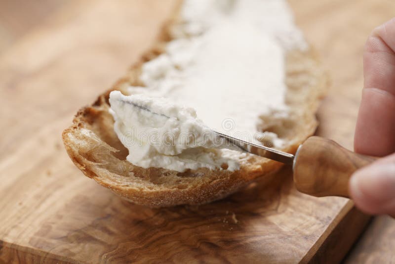 Spreading Ricotta Cheese on Fresh Rustic Bread Stock Photo - Image of ...
