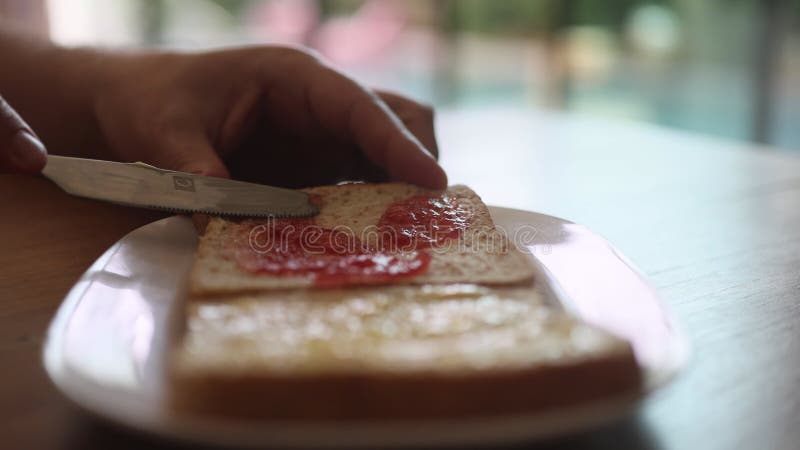 Spreading Strawberry Jam on Bread. Knife Smearing Strawberry Jam on ...