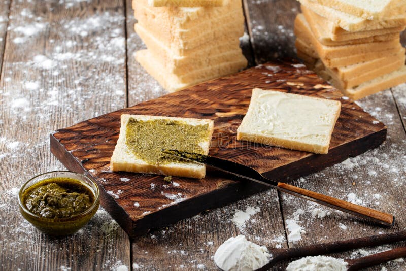 Spreading White Bread Slice with Pesto Sauce Stock Photo - Image of ...