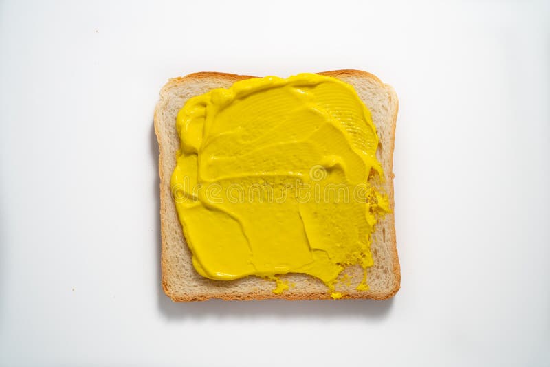 Spreading Yellow Paste on a Toast on White Background. Top View Stock ...