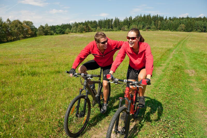 Spring Bike - Young Sportive Couple in Meadow Stock Image - Image of ...
