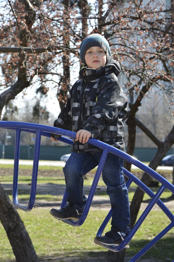 Spring Boy Playing on the Playground. Stock Photo - Image of little ...