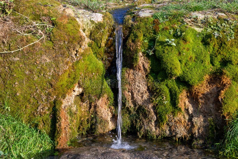 Spring with Clean Water Flowing from Stones. Mineral Water in Nature ...